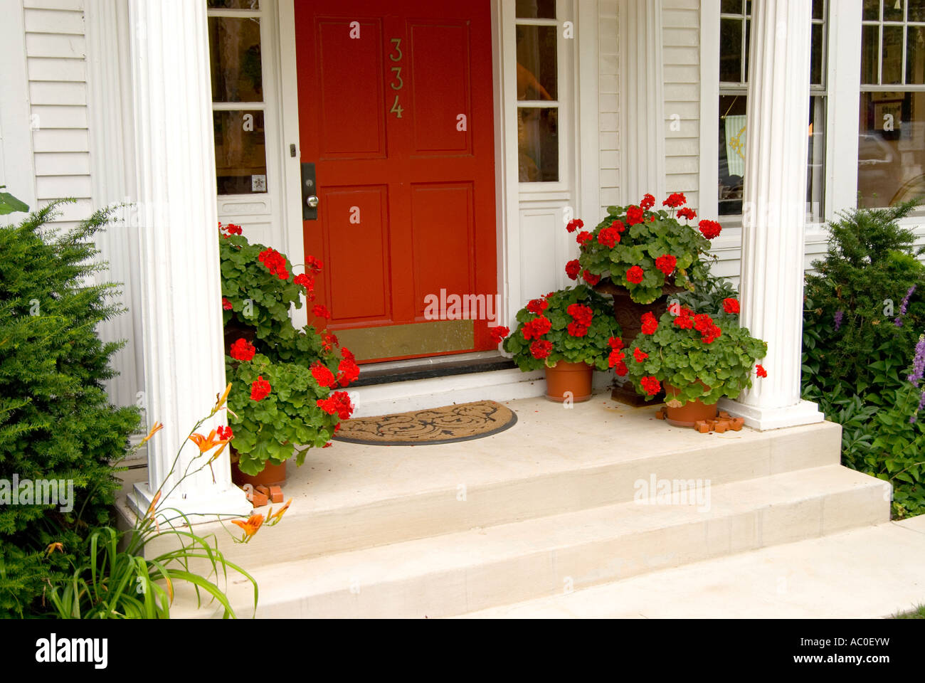 Red Front Door & Potted Geraniums at home entrance Stock Photo - Alamy