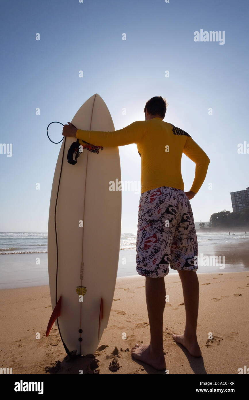 A surfer looks out to the waves at Manly Beach on Sydney's north shore ...