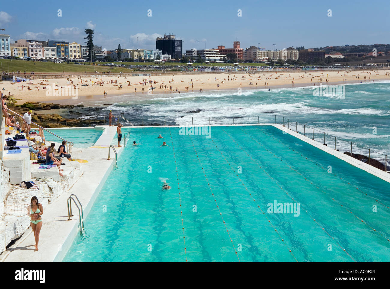 Visitors sunbathe and relax at the Bondi Baths ocean filled pools at ...