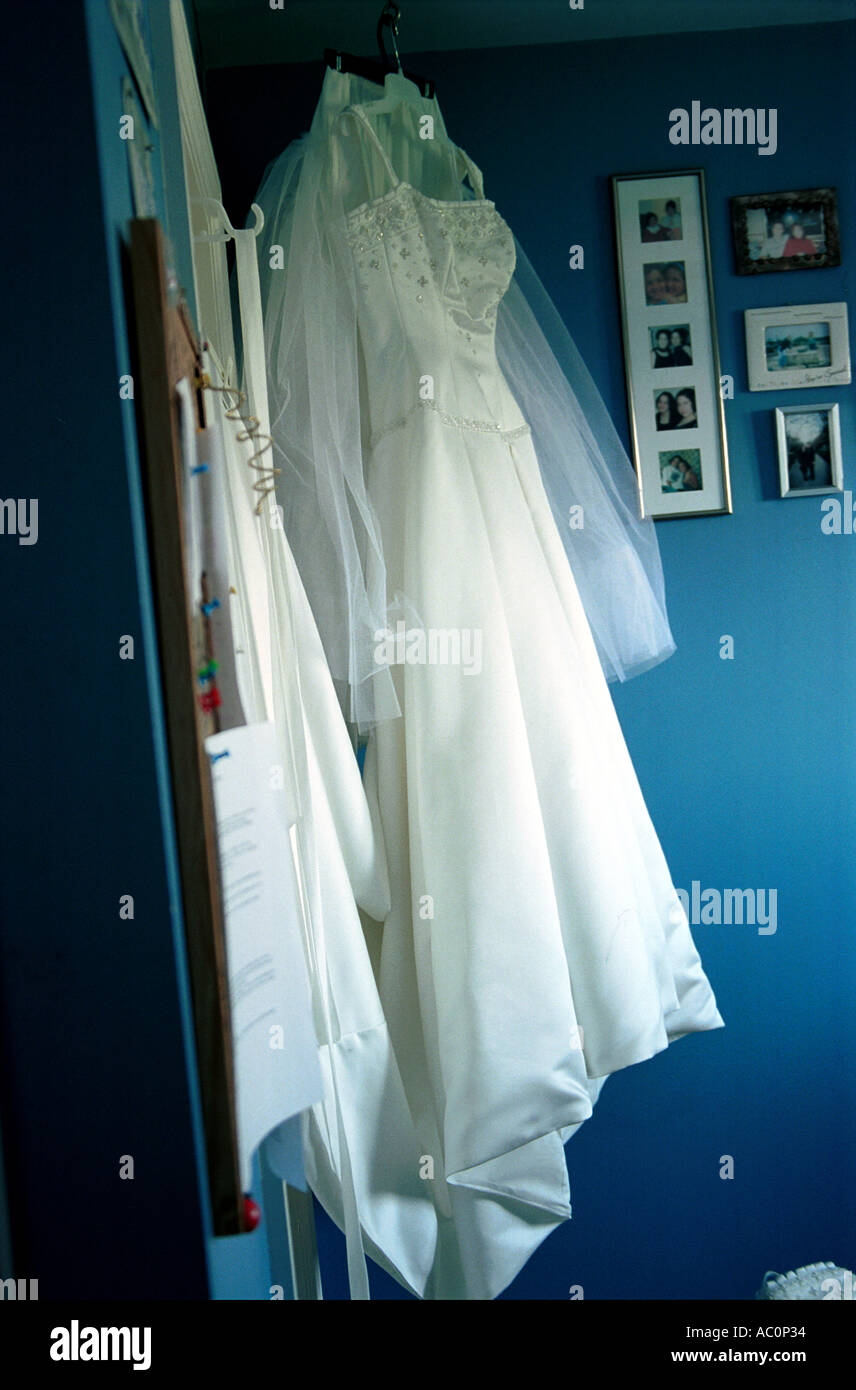wedding dress hanging up before bride wears it Stock Photo - Alamy