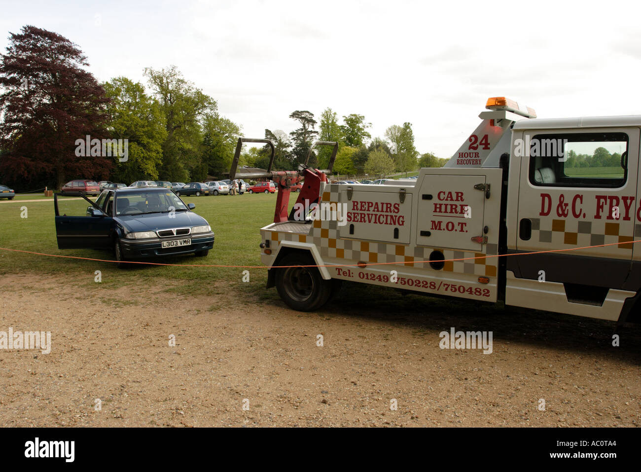 Broken down car being loaded onto the back of a breakdown rescue lorry ...