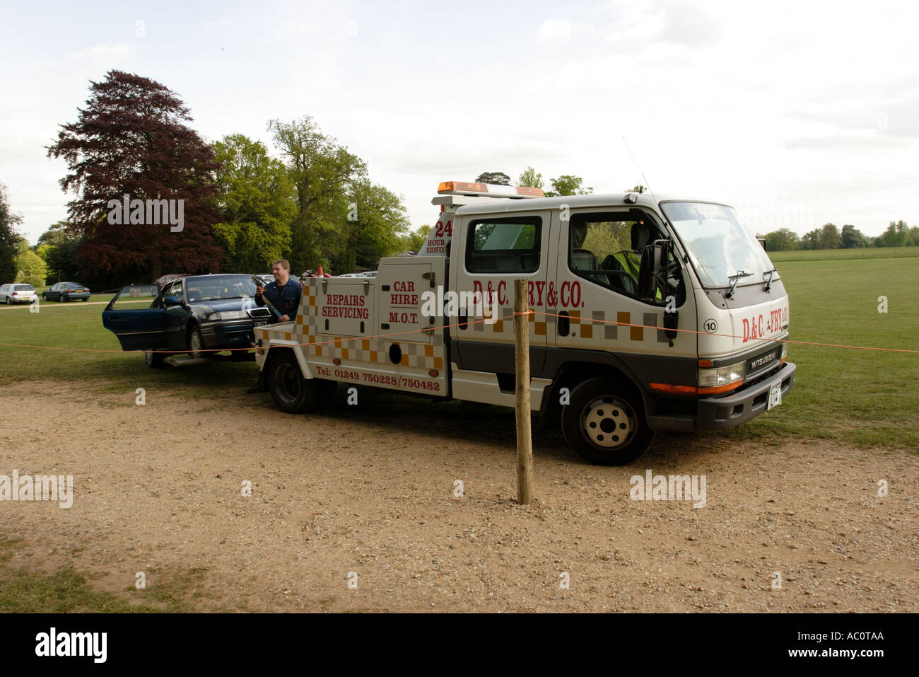 Broken down car being loaded onto the back of a breakdown rescue lorry ...
