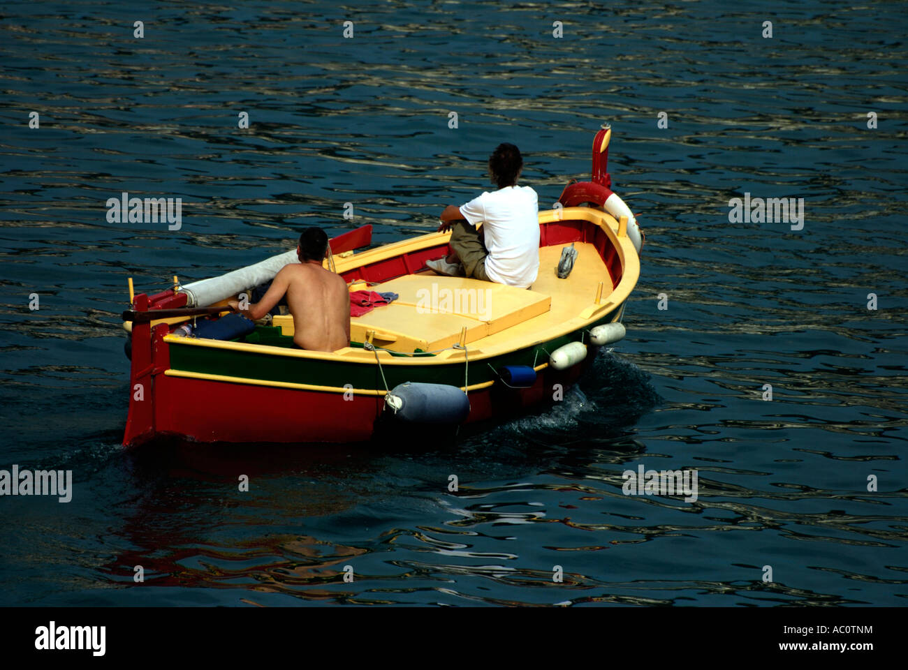 two men in a small fishing boat Stock Photo - Alamy