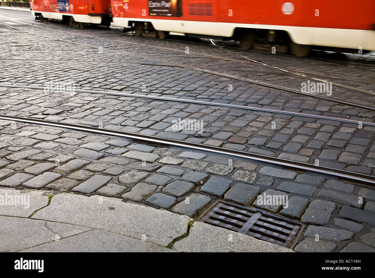 Tram passing over Tram tracks on cobbled stone in Prague Stock Photo ...