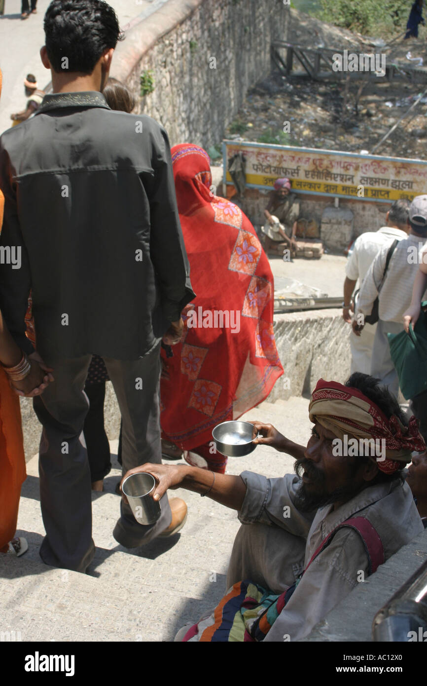 begging on the steps by the Ganges Stock Photo - Alamy