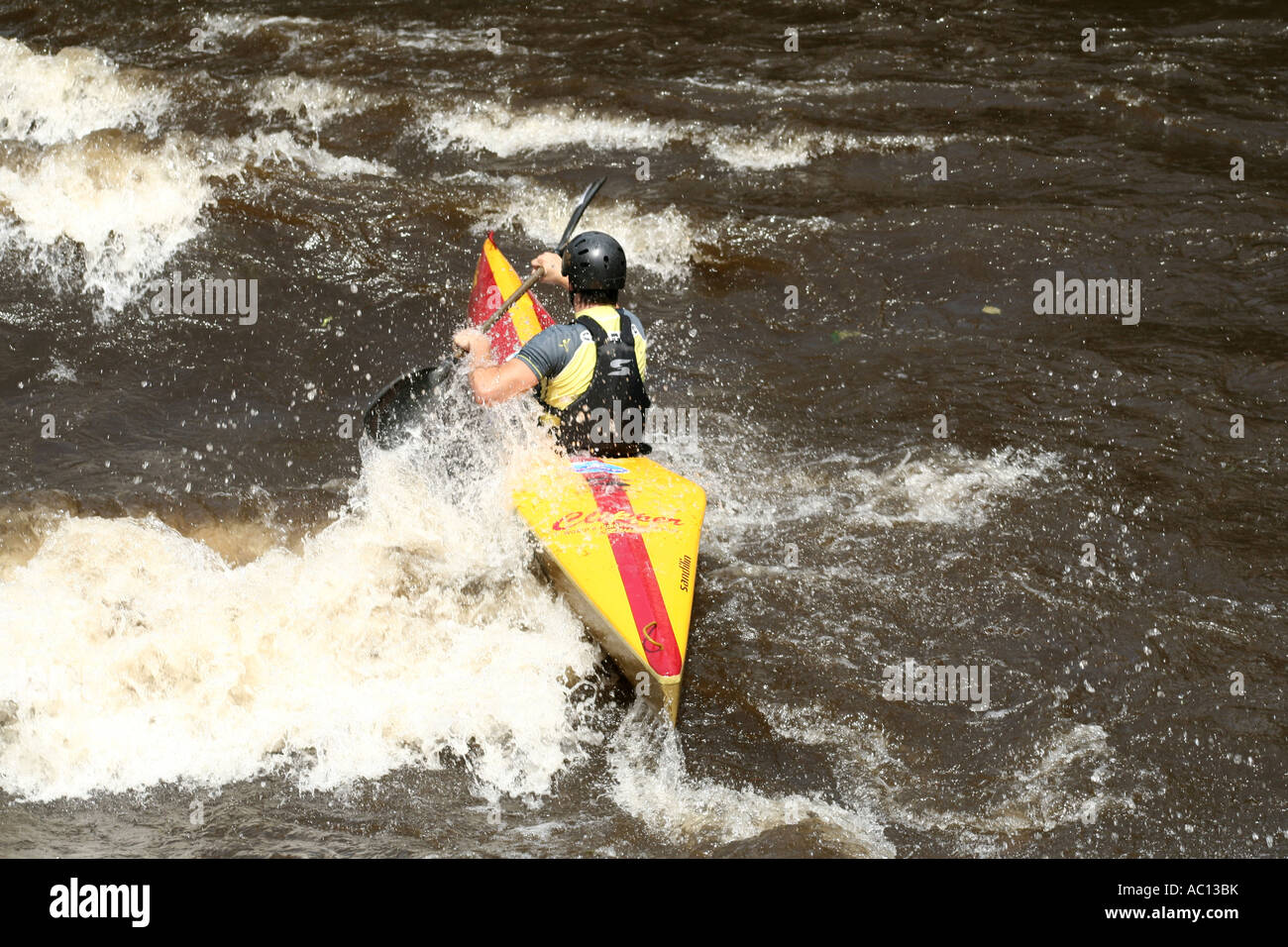 A kayaker maneuvers through the turbulent waters of a river in Karlovy ...