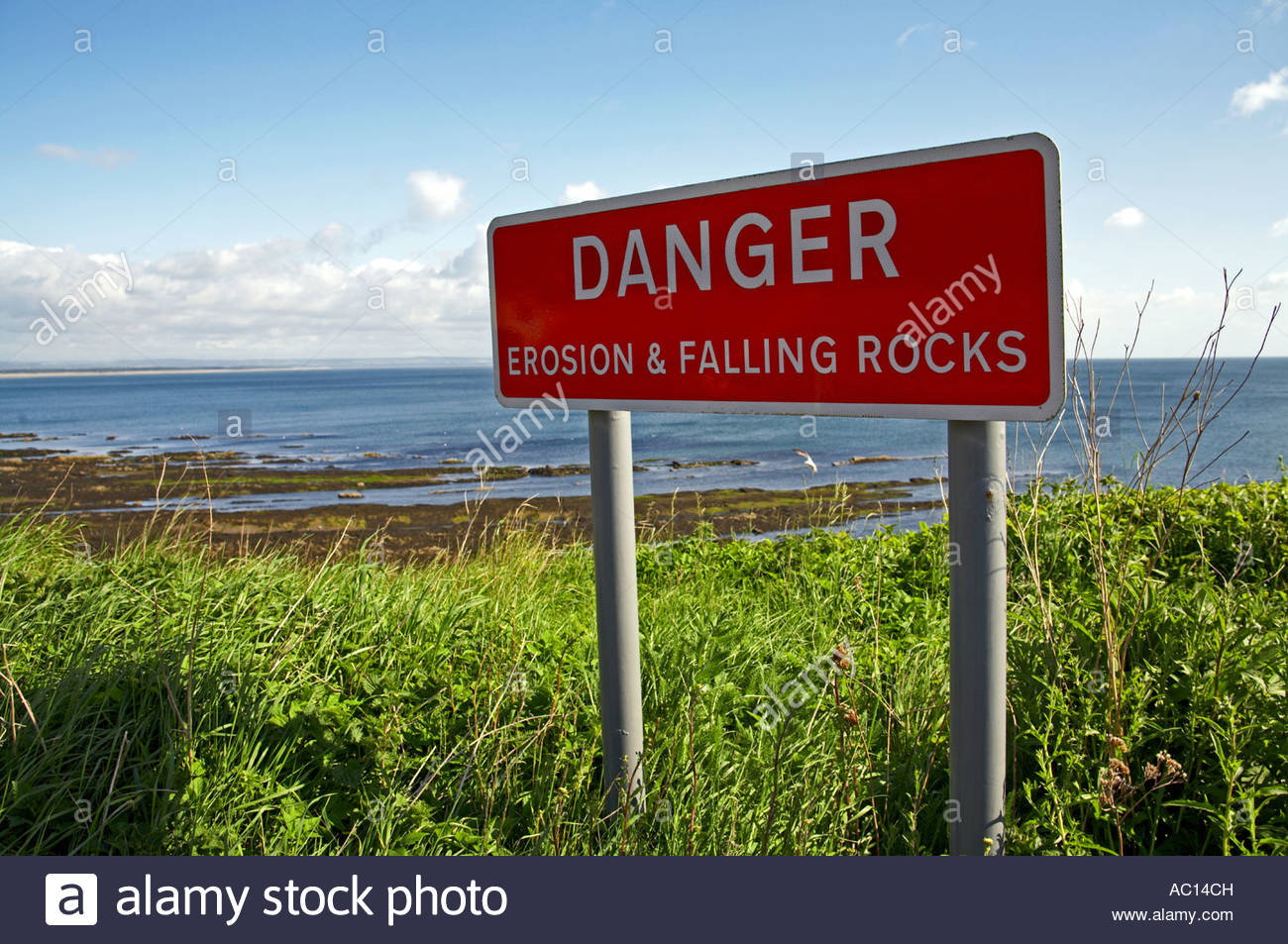 Danger Erosion and falling rocks signpost at coastal edge Stock Photo ...