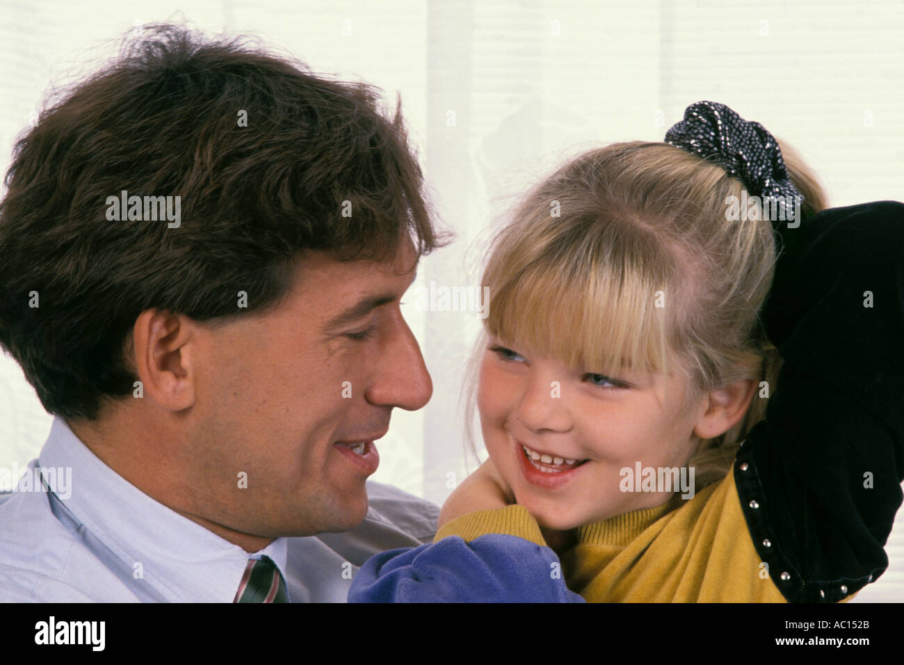 Portrait of European Caucasian father and his blond daughter smiling to ...