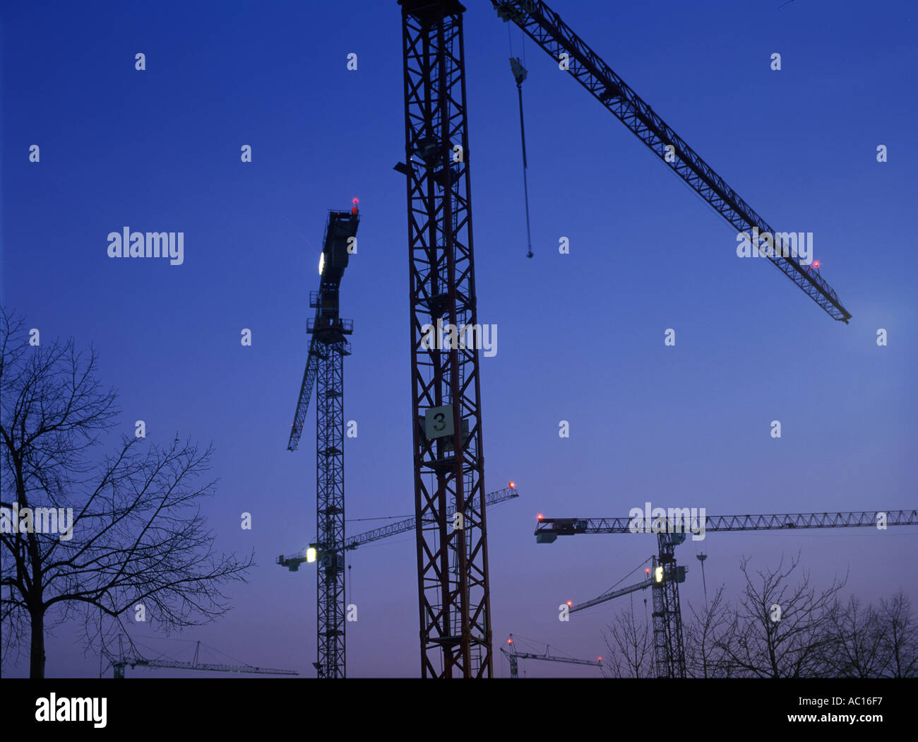 Erection cranes in the sunset light Stock Photo - Alamy