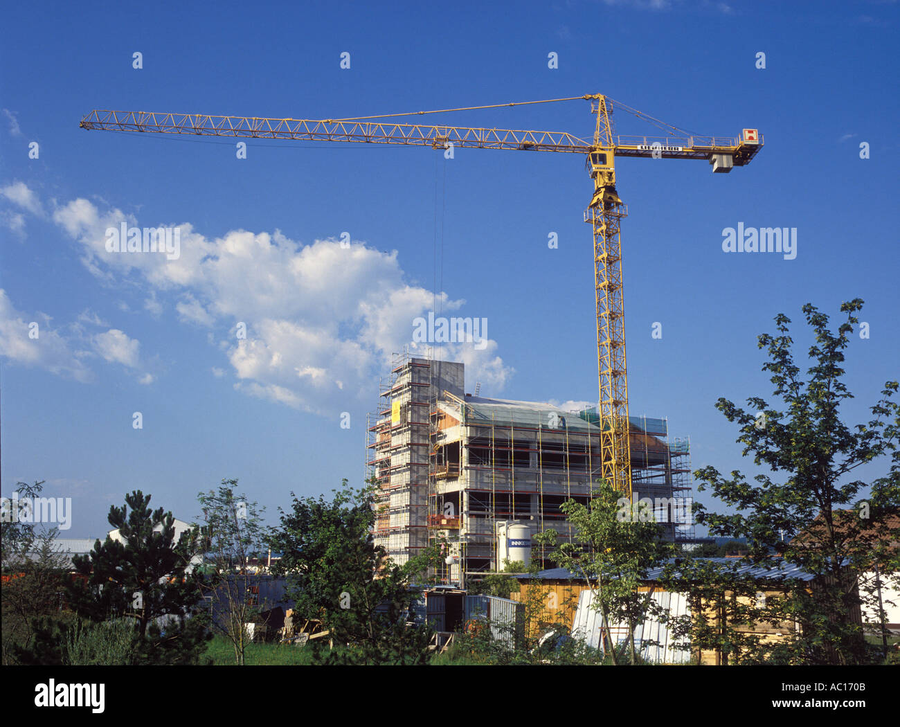 Building site crane over structure of a house with scaffold Stock Photo ...