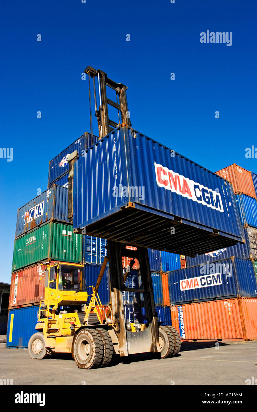 Shipping Industry / A Fork Lift stacks a container at a Shipping Depot ...