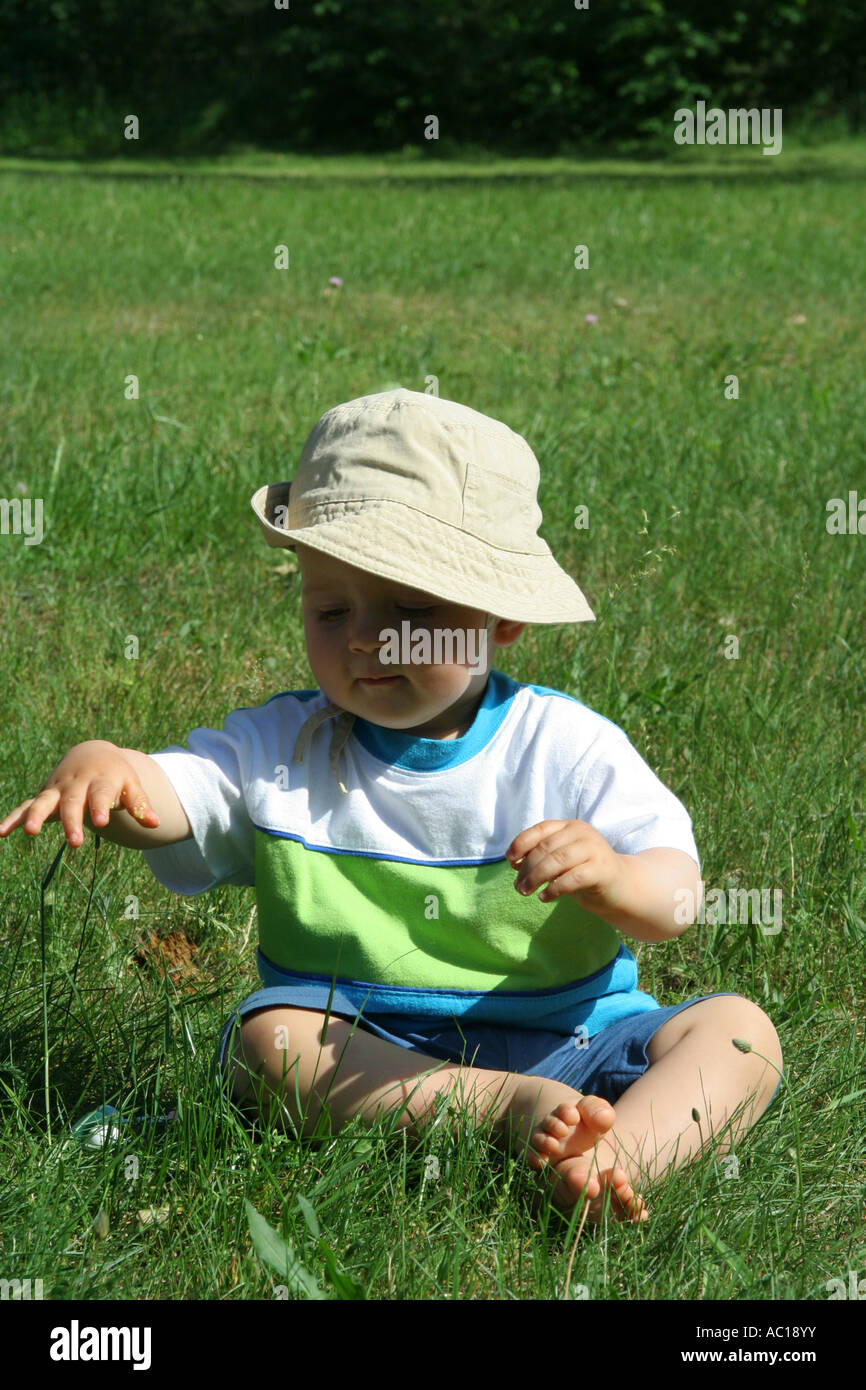 Boy sitting on the grass Stock Photo - Alamy