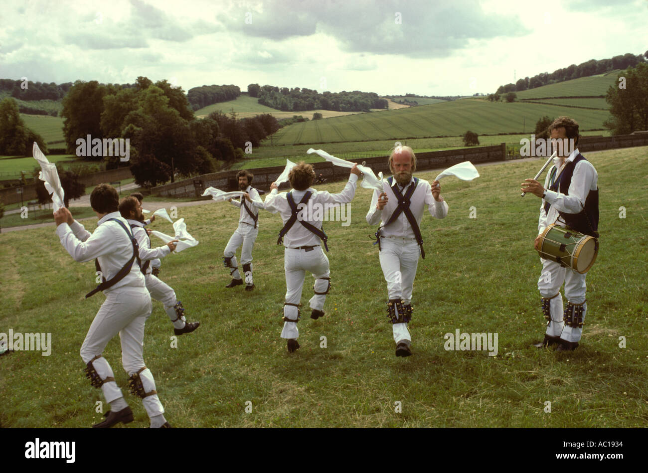 Traditional English folk music. Man playing a penny whistle and a drum ...