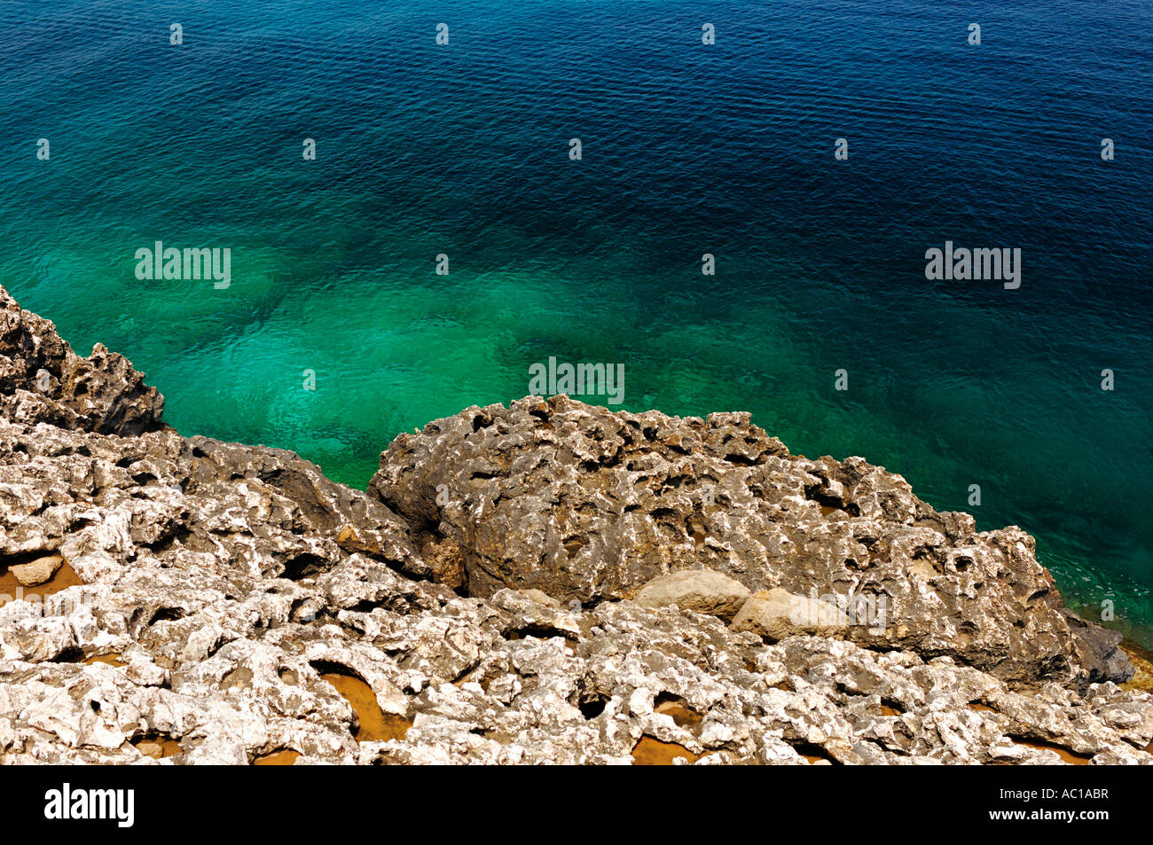 Rocky seashore with clear green Mediterranean Sea water Stock Photo - Alamy