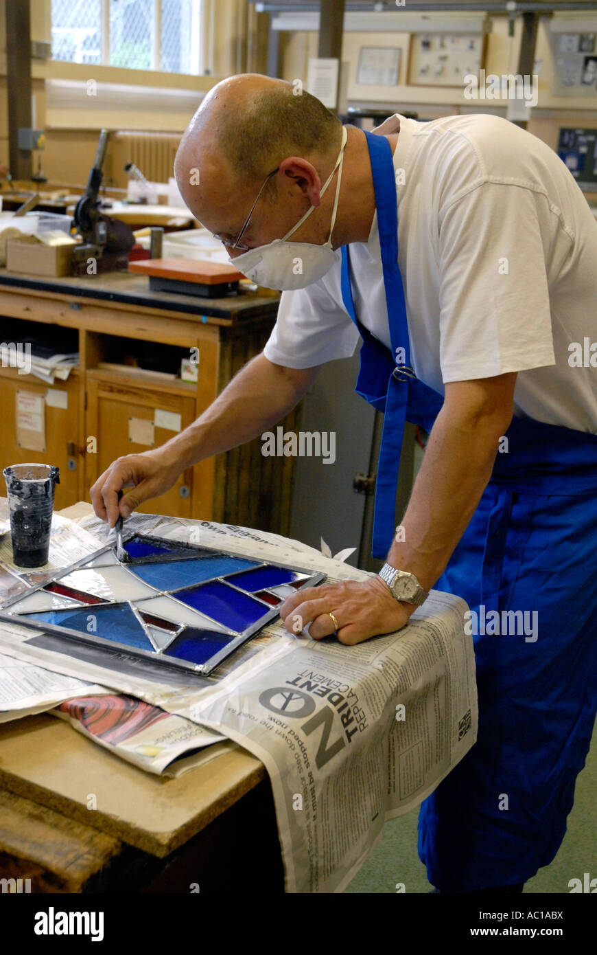 Woman working on stained Glass panel in adult learning class Stock ...