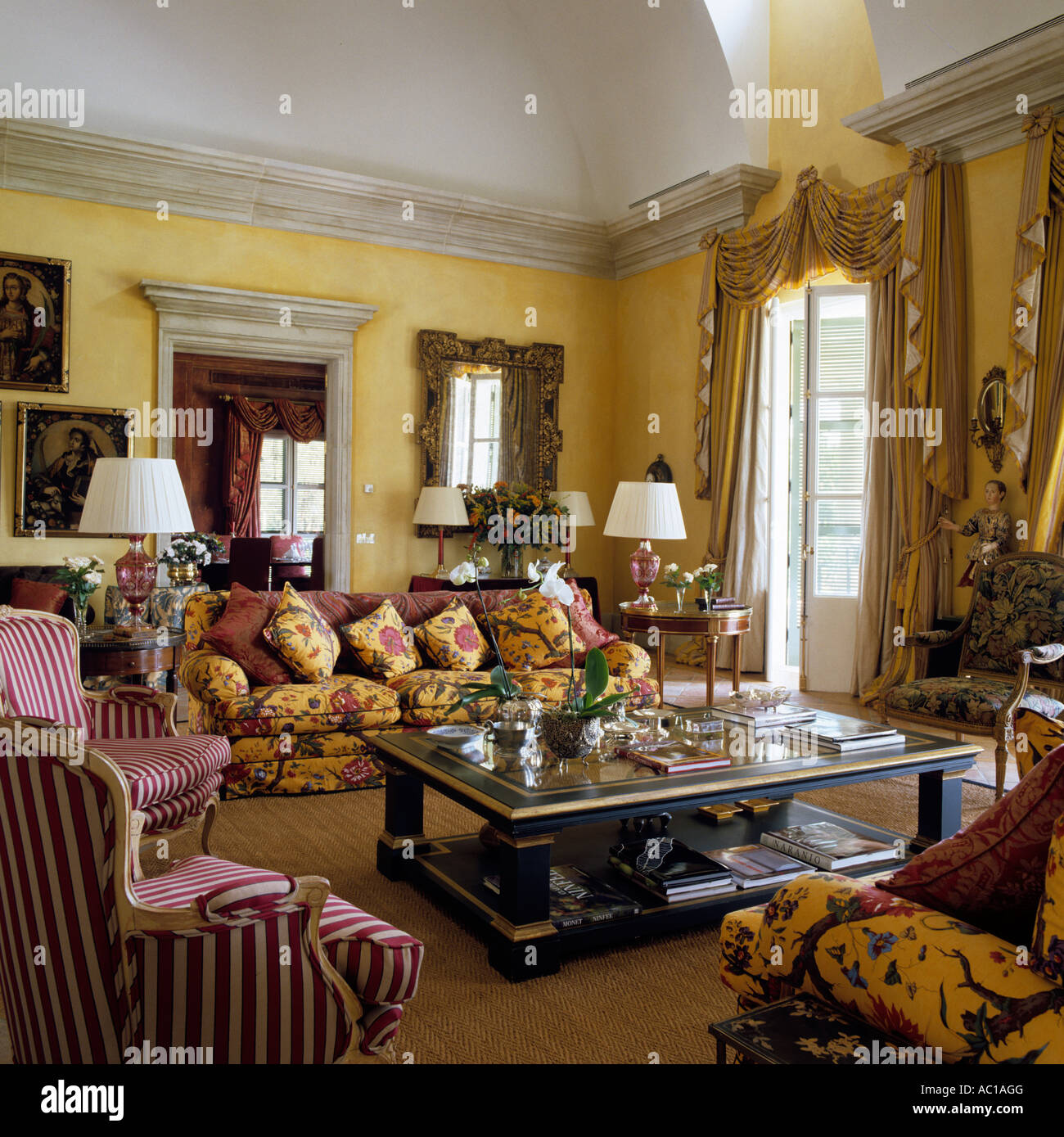 Yellow painted drawing room with upholstered seating and vaulted ...