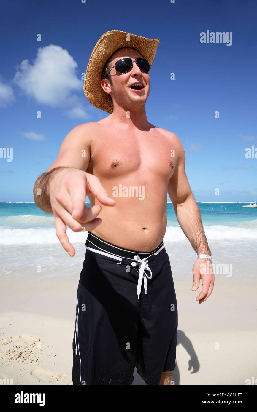 Man standing on beach, pointing Stock Photo - Alamy