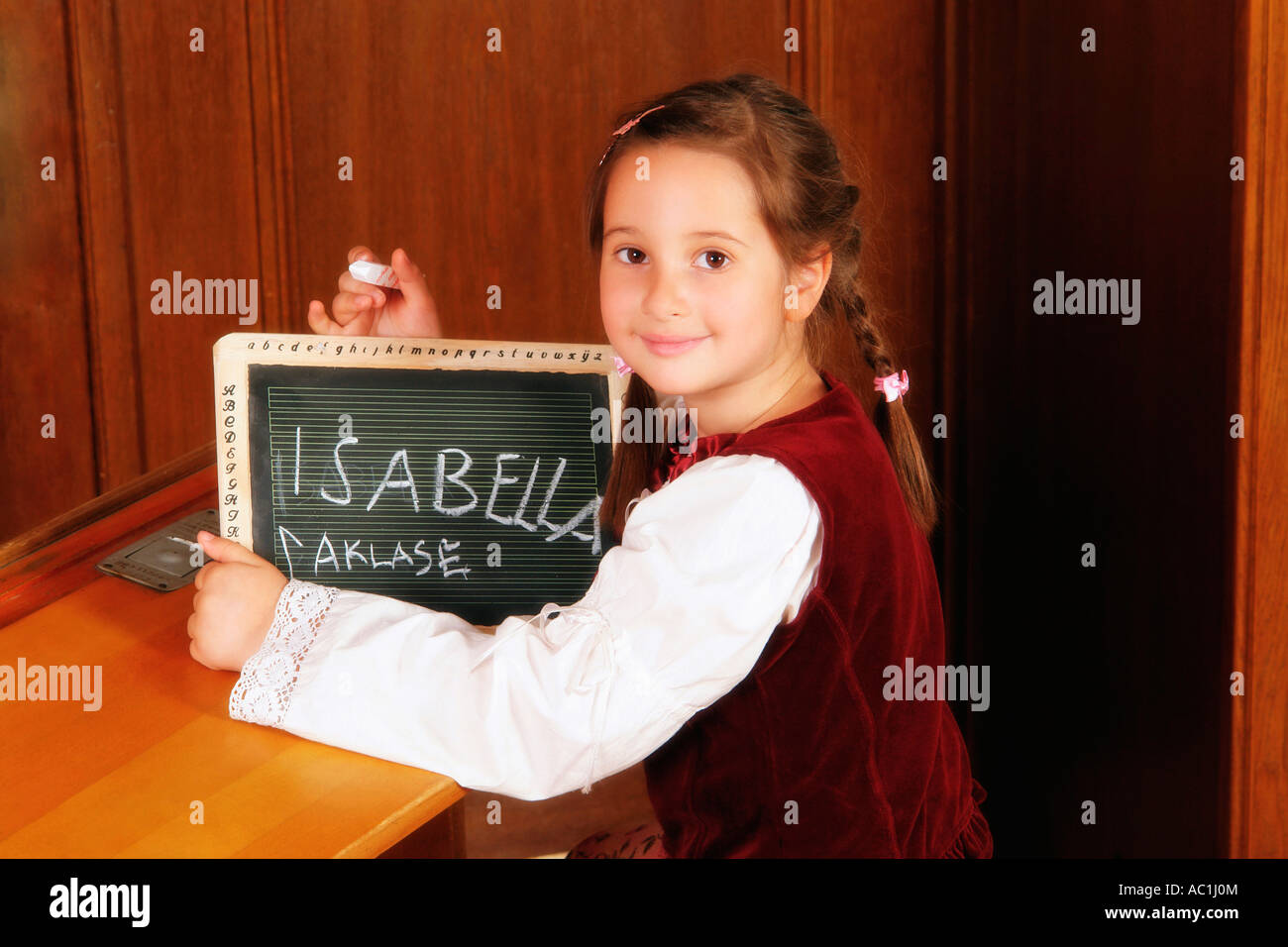 Girl in class room writing on board Stock Photo - Alamy