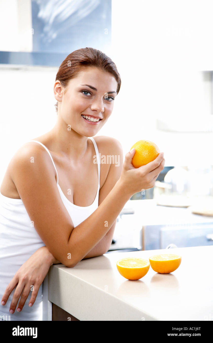 Young woman holding orange Stock Photo - Alamy Young woman holding orange Stock Photo - Alamy
