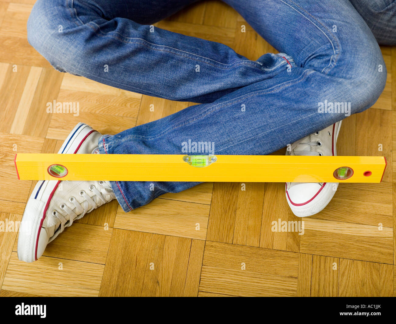 Woman sitting on floor with water level on feet, low section Stock ...
