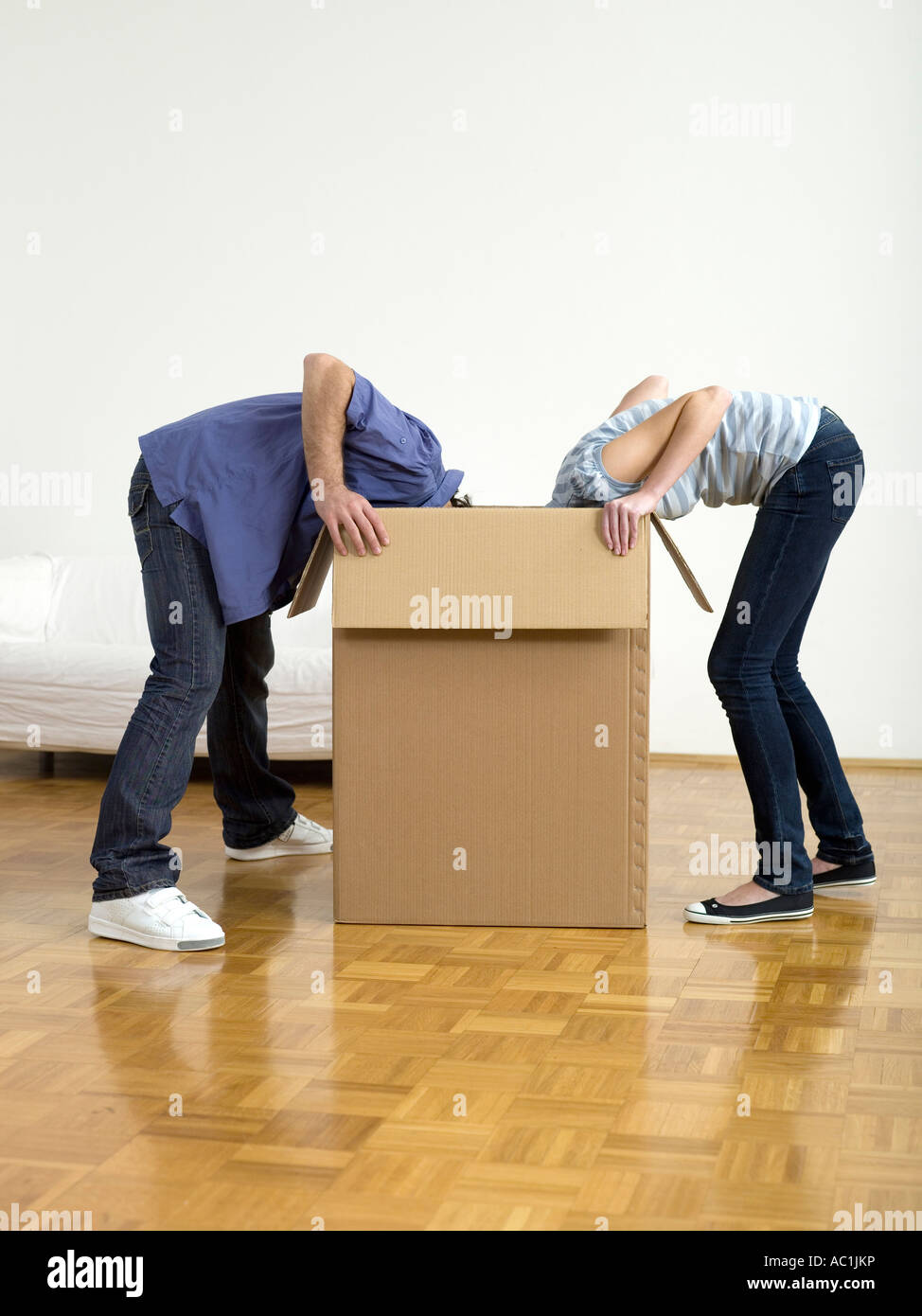 Couple looking in box Stock Photo - Alamy