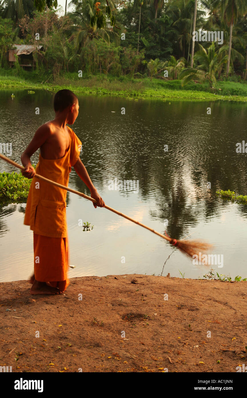 Young Buddhist Monk Sweeping Up Leaves By Lakeside Thailand 2 Stock ...