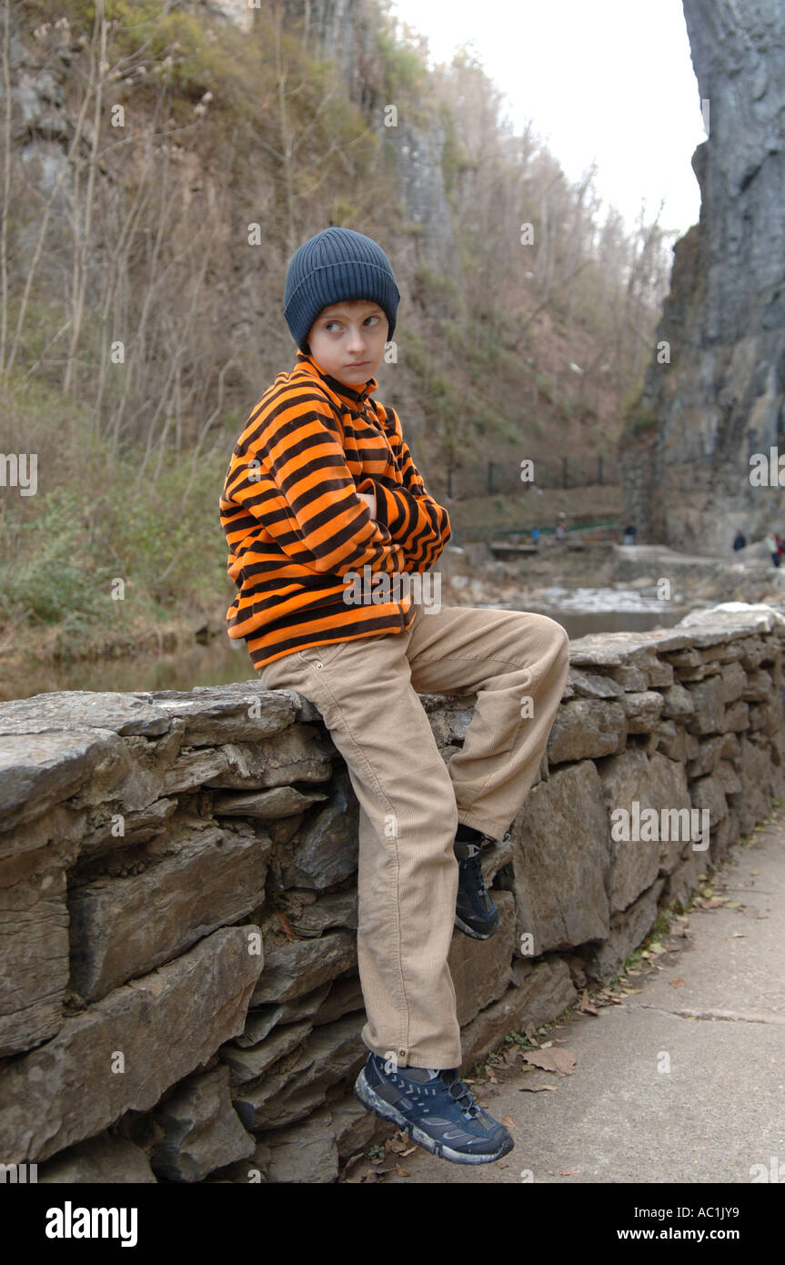 Sad boy sitting on stone hi-res stock photography and images - Alamy