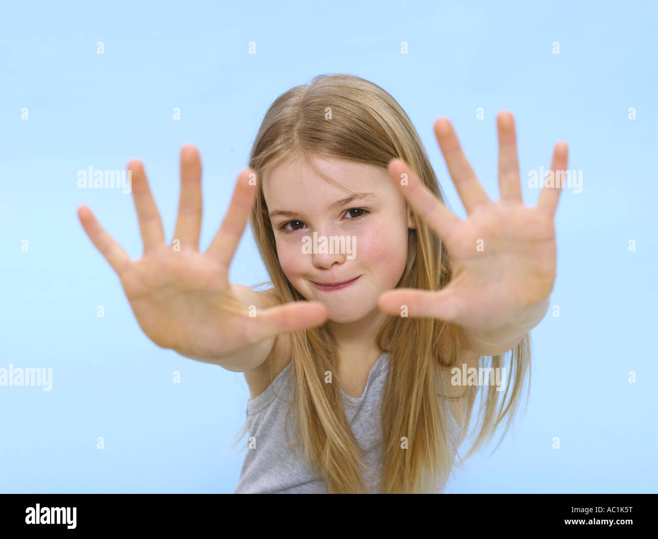 Girl showing palms Stock Photo - Alamy