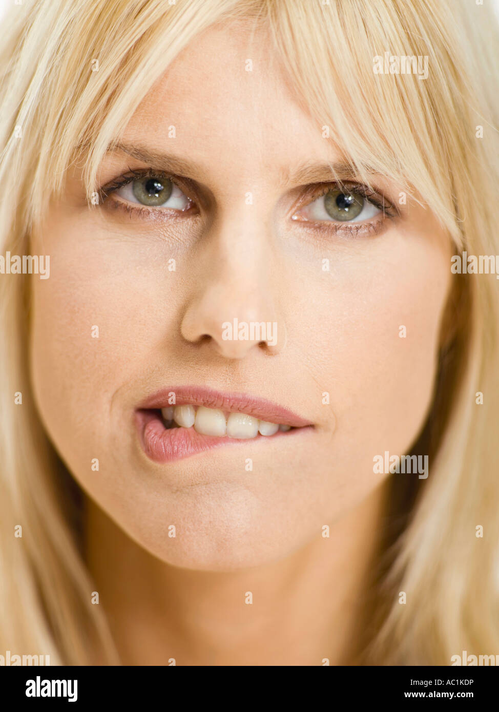 Woman biting lips, portrait Stock Photo - Alamy