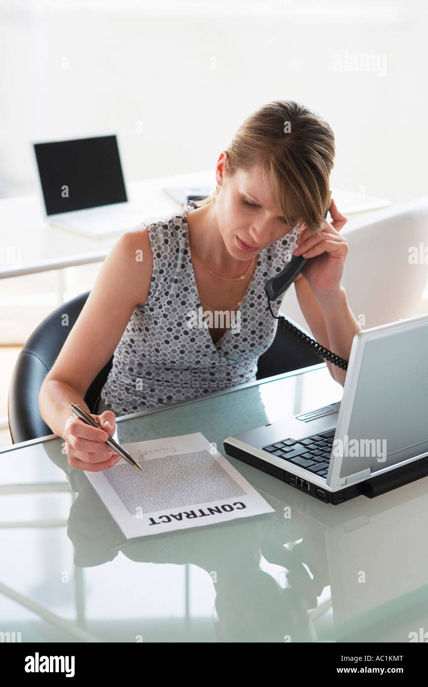 Woman checking contract Stock Photo - Alamy