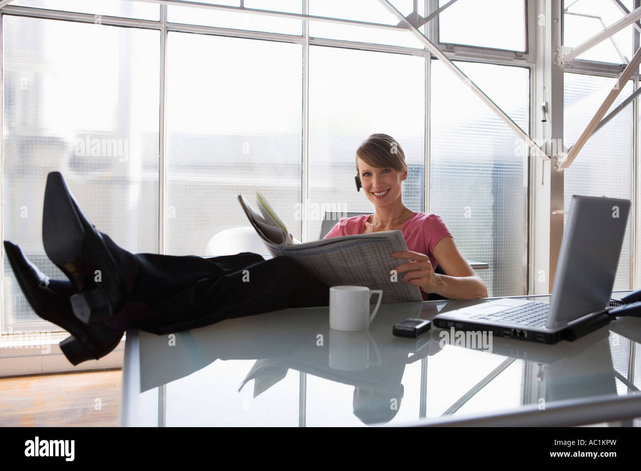 Business woman relaxing at her desk feet on table top Stock Photo - Alamy