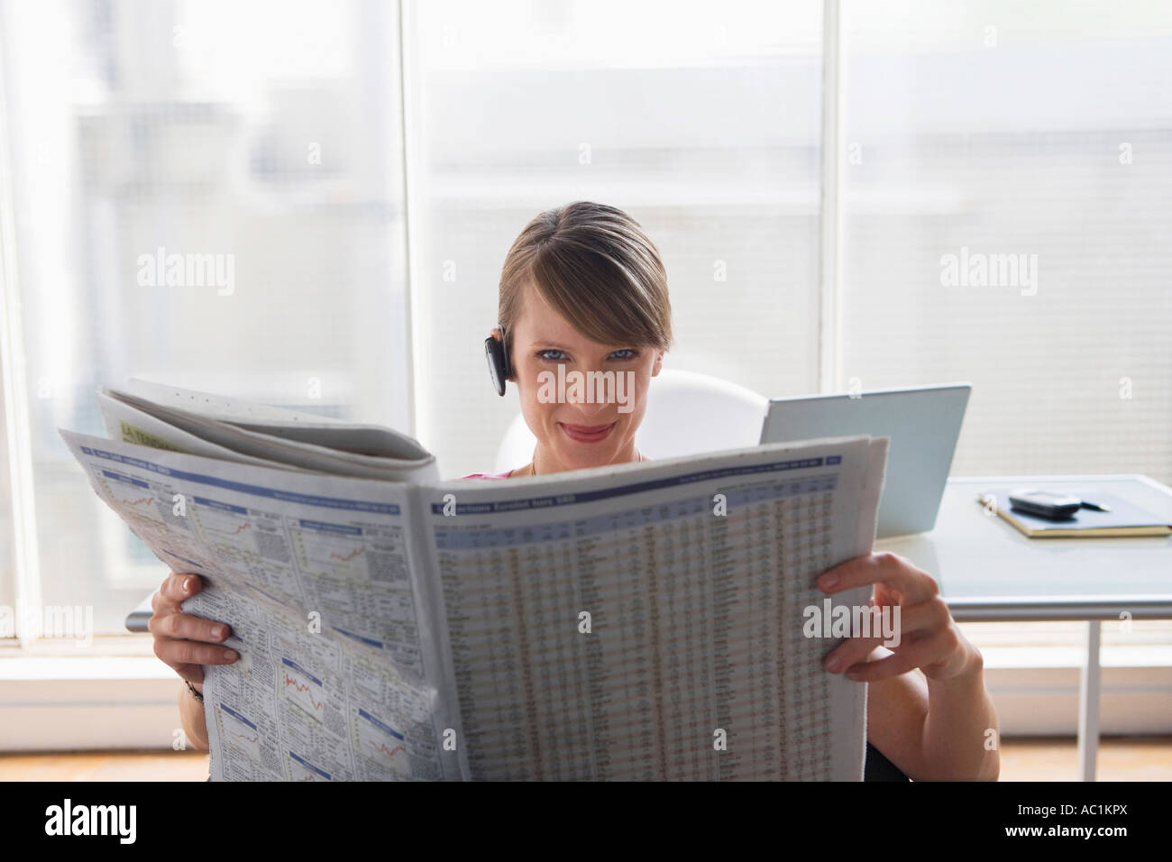 Woman reading financial newspaper Stock Photo - Alamy