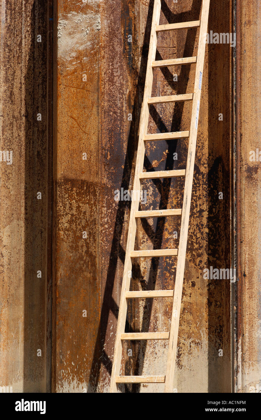 Ladder leaning against wall Stock Photo - Alamy