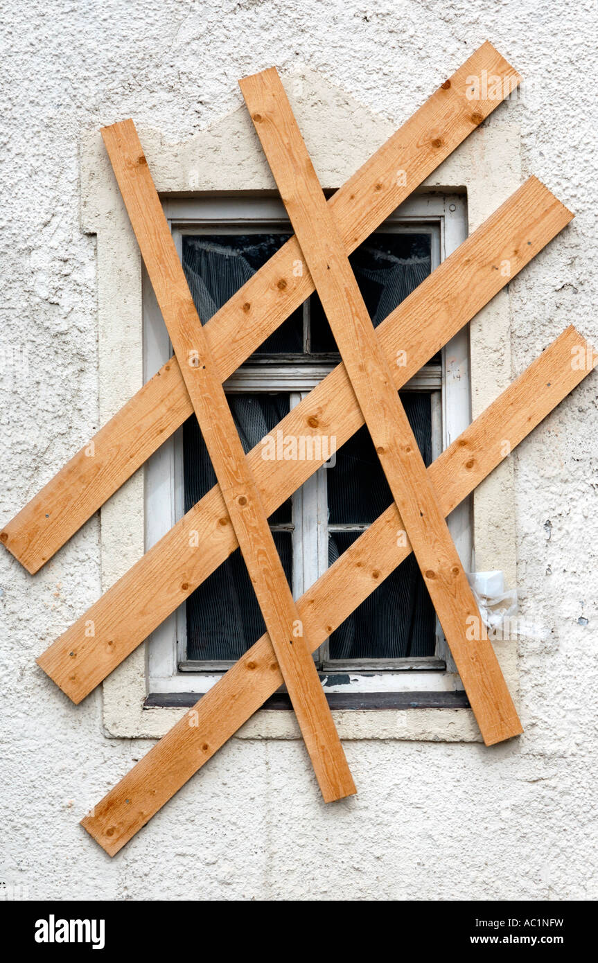 Window nailed up with wooden boards Stock Photo - Alamy