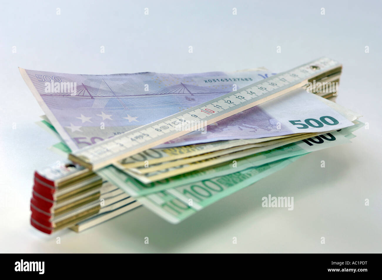 Bank notes and folding ruler Stock Photo - Alamy