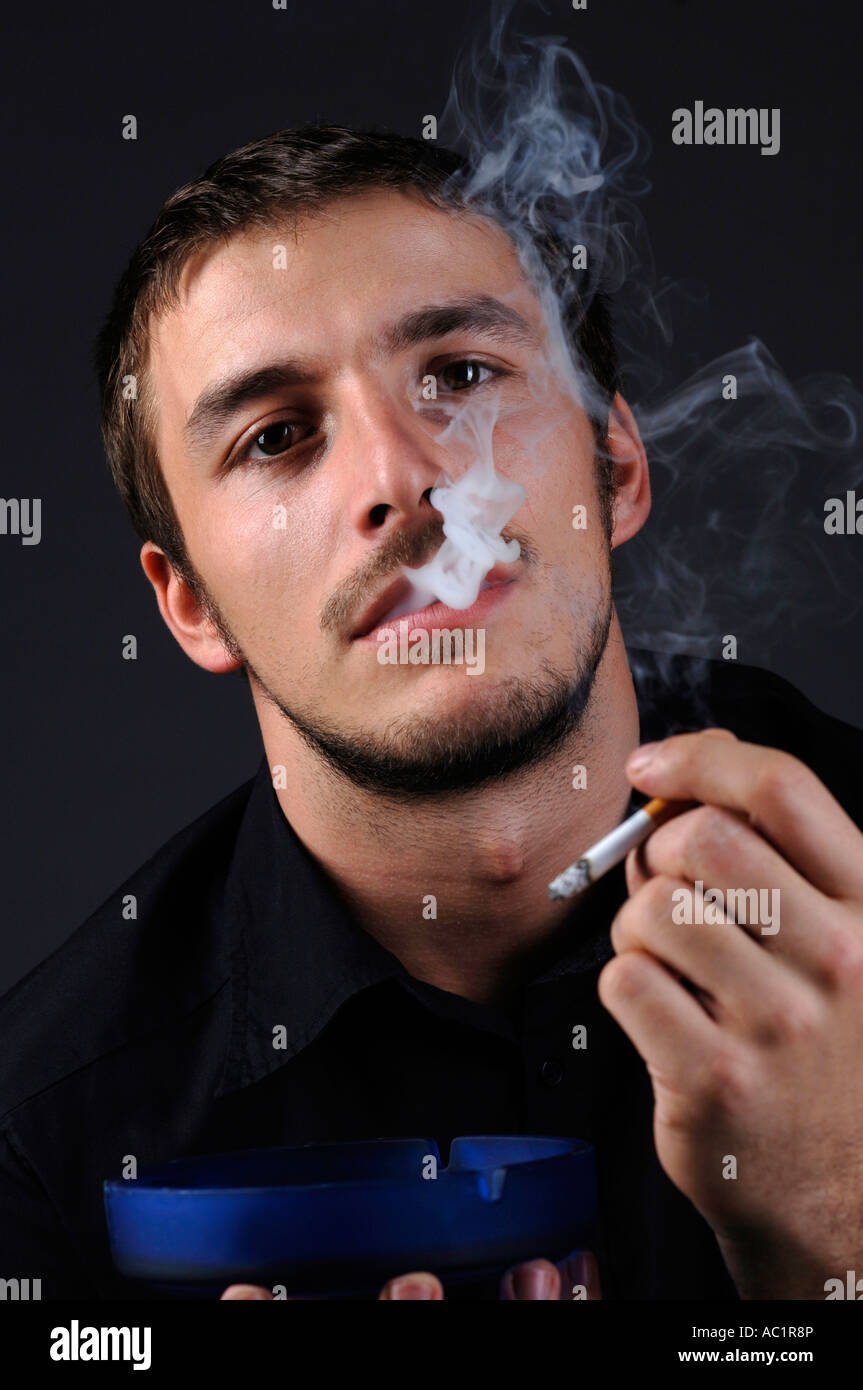 Man lighting a cigarette, portrait Stock Photo - Alamy