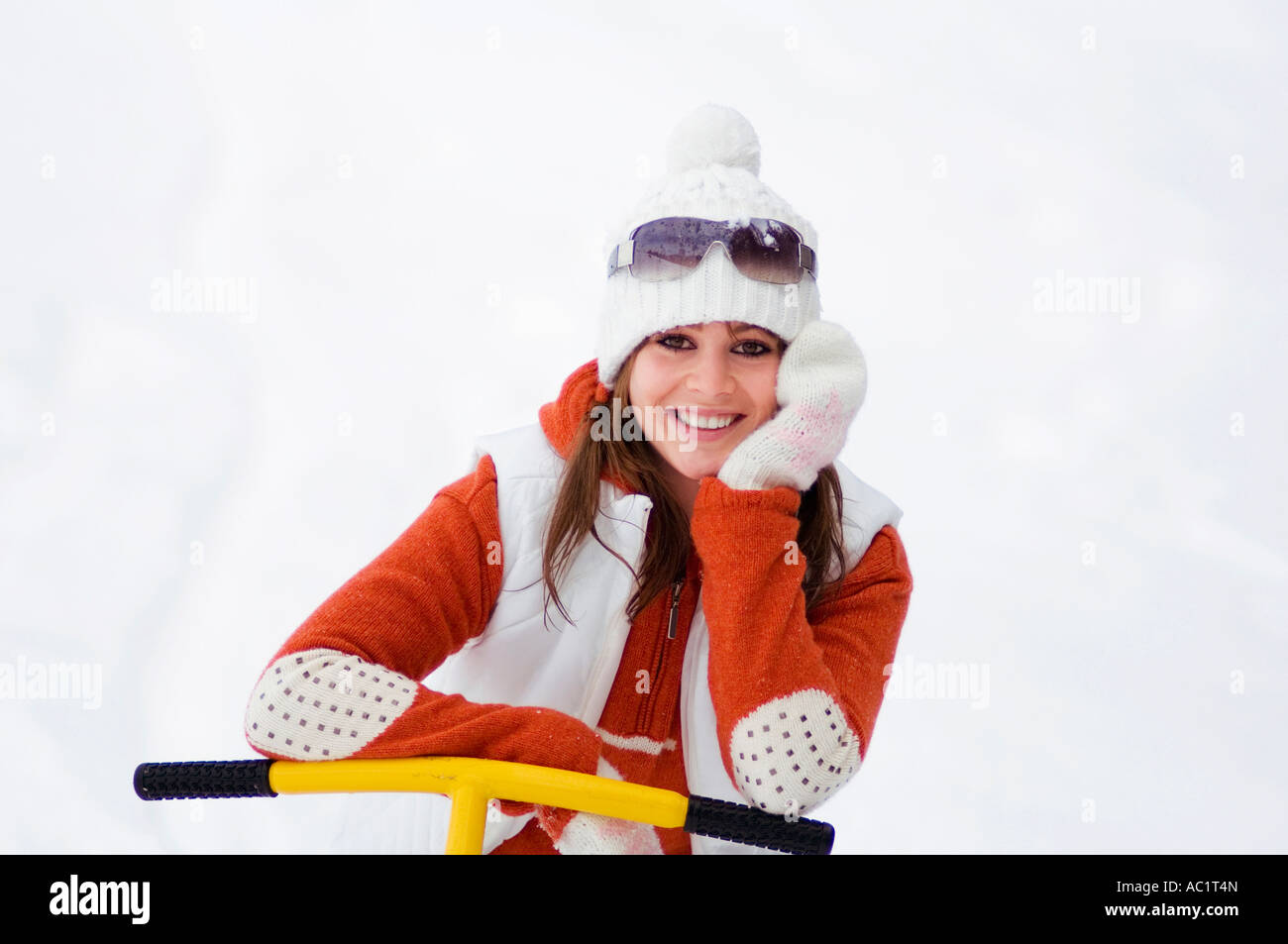 Young woman on sledge, portrait Stock Photo - Alamy