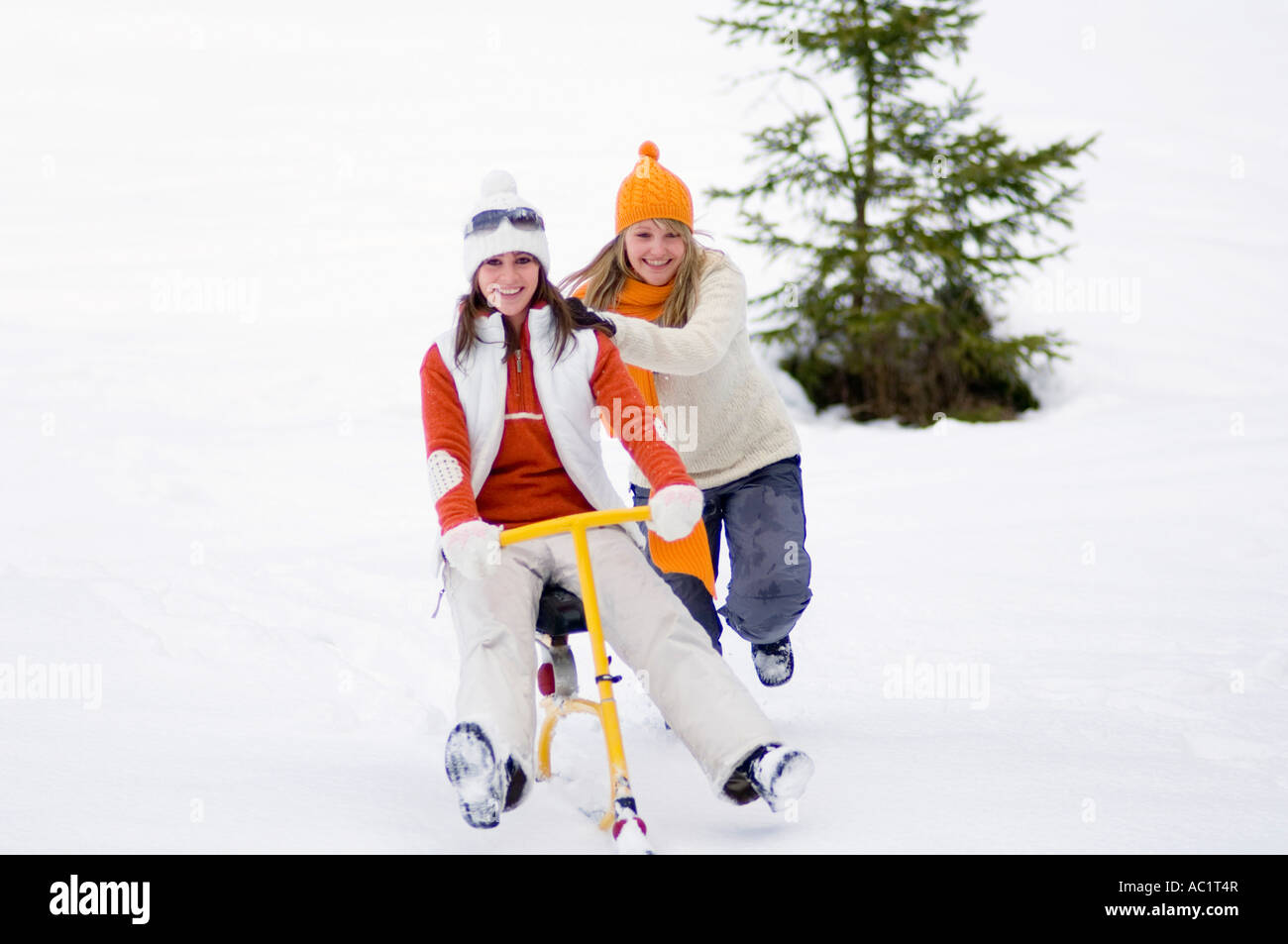 Young women on sledge Stock Photo - Alamy