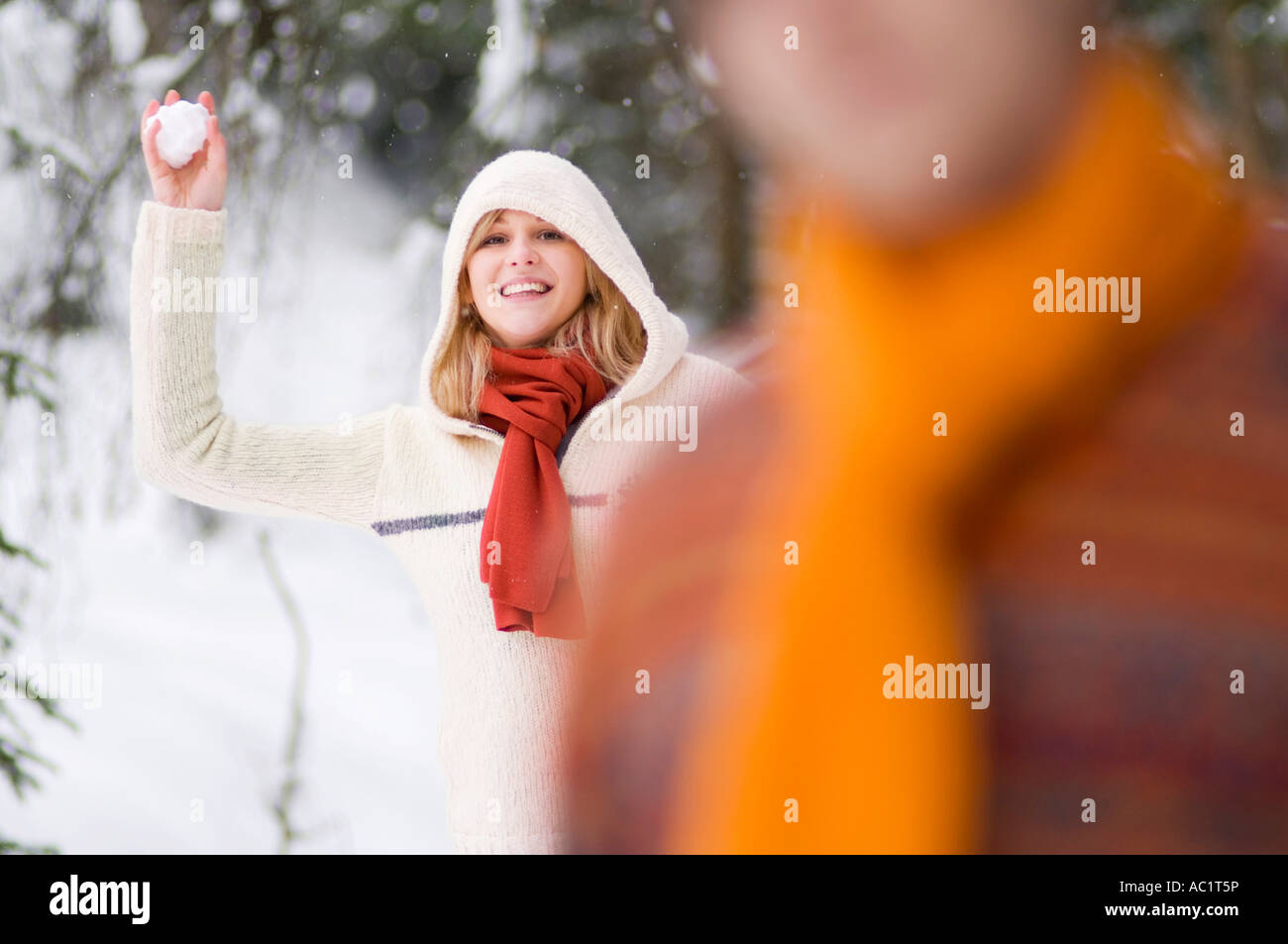 Woman throwing snowball Stock Photo - Alamy