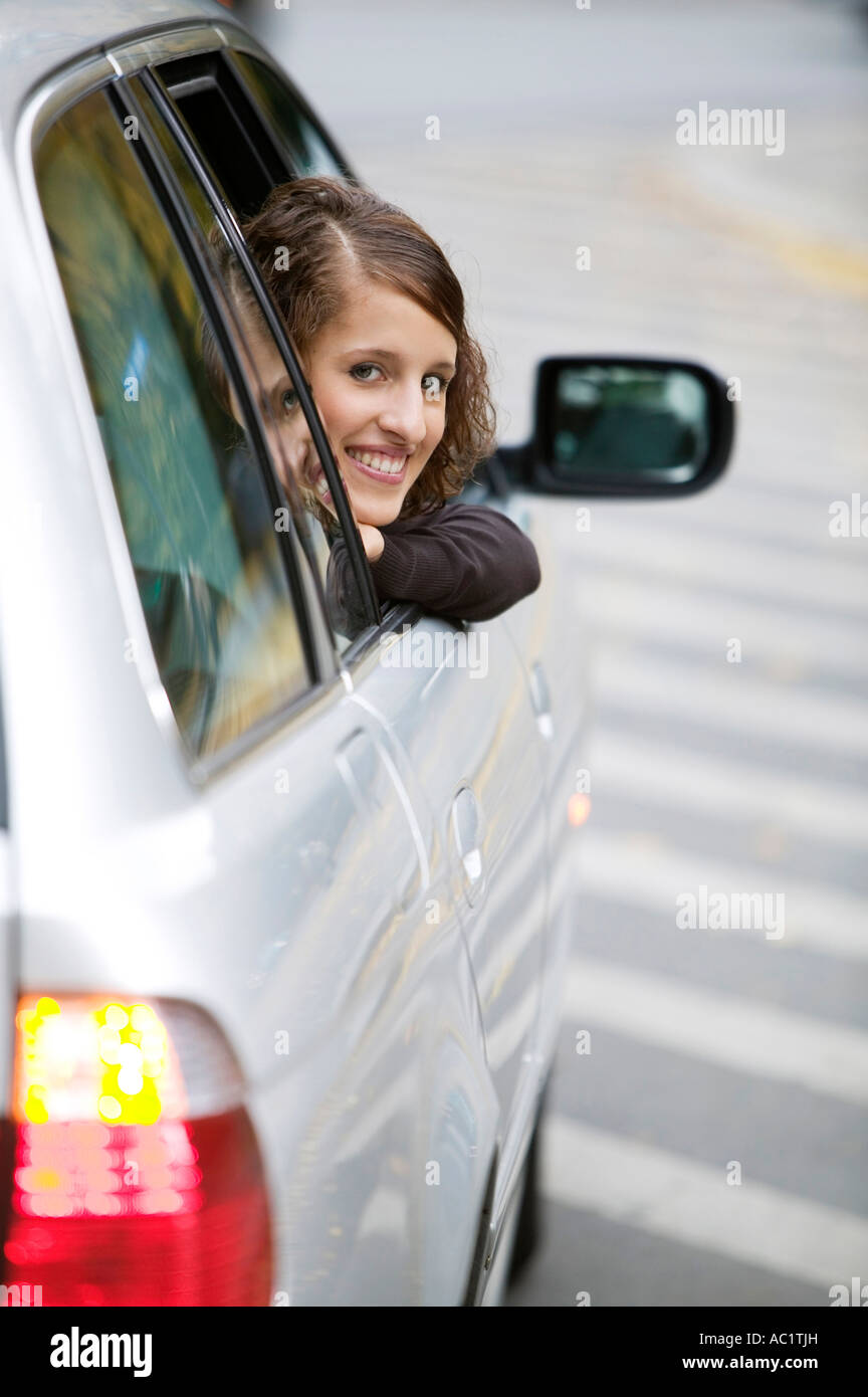 Young woman looking out of car, smiling Stock Photo - Alamy Young woman looking out of car, smiling Stock Photo - Alamy