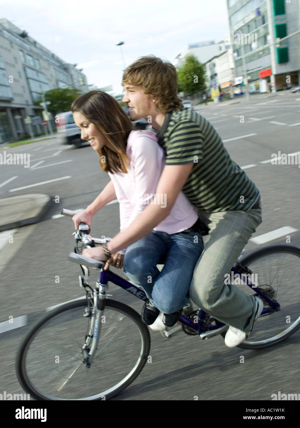 Young couple on bike Stock Photo - Alamy