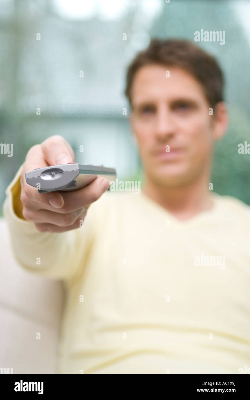 Young man zapping Stock Photo - Alamy