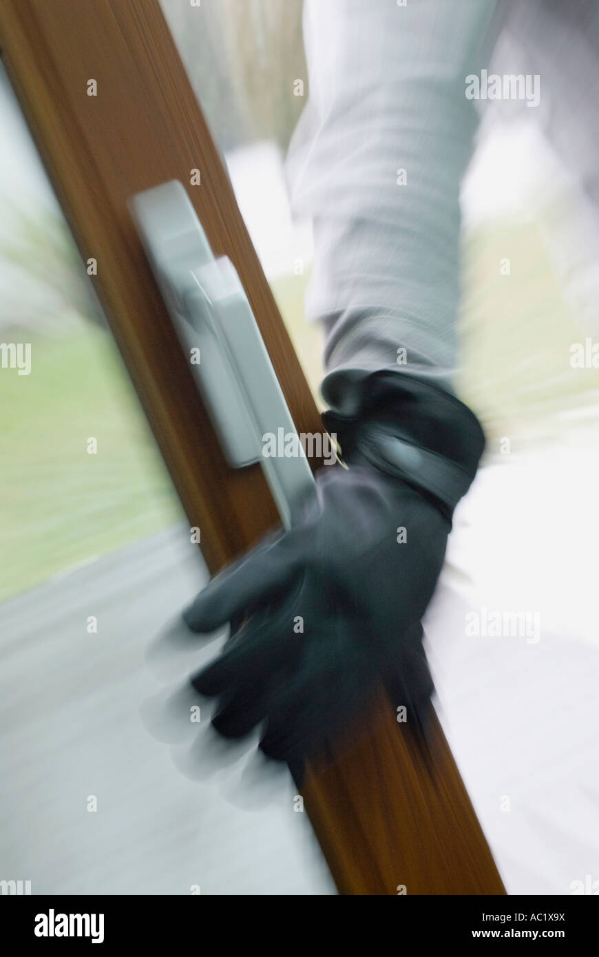 Burglary, gloved hand opening terrace door Stock Photo - Alamy