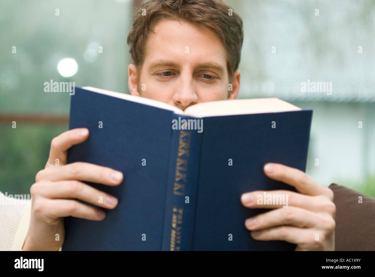Man reading book Stock Photo - Alamy
