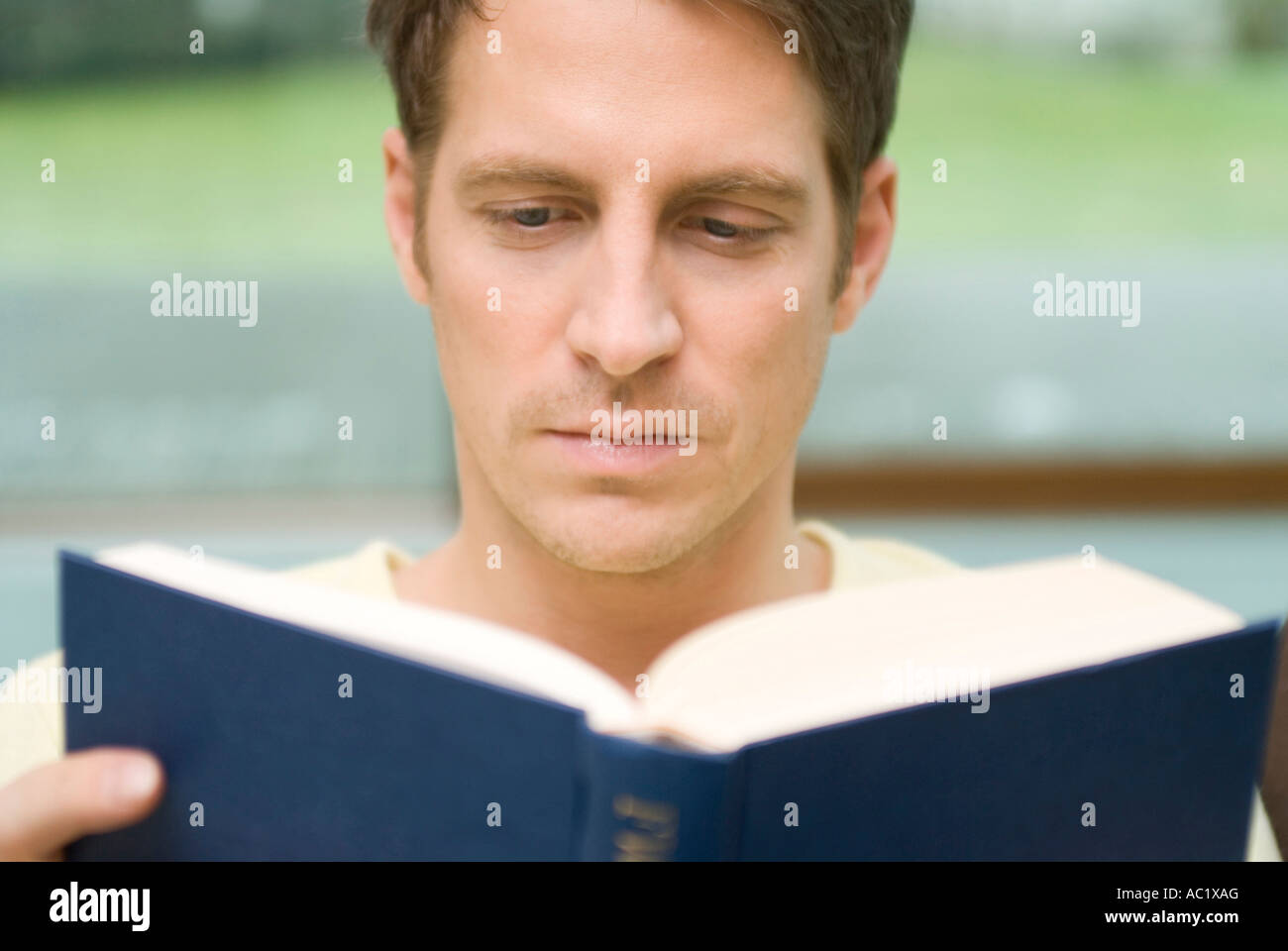 Man reading book Stock Photo - Alamy