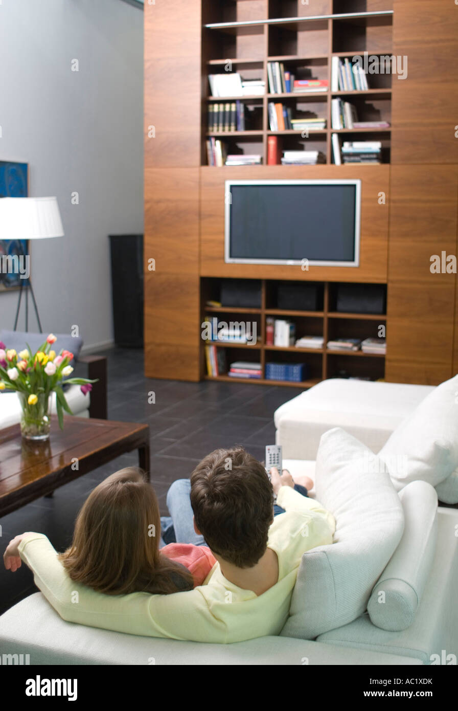 Young couple watching TV Stock Photo - Alamy