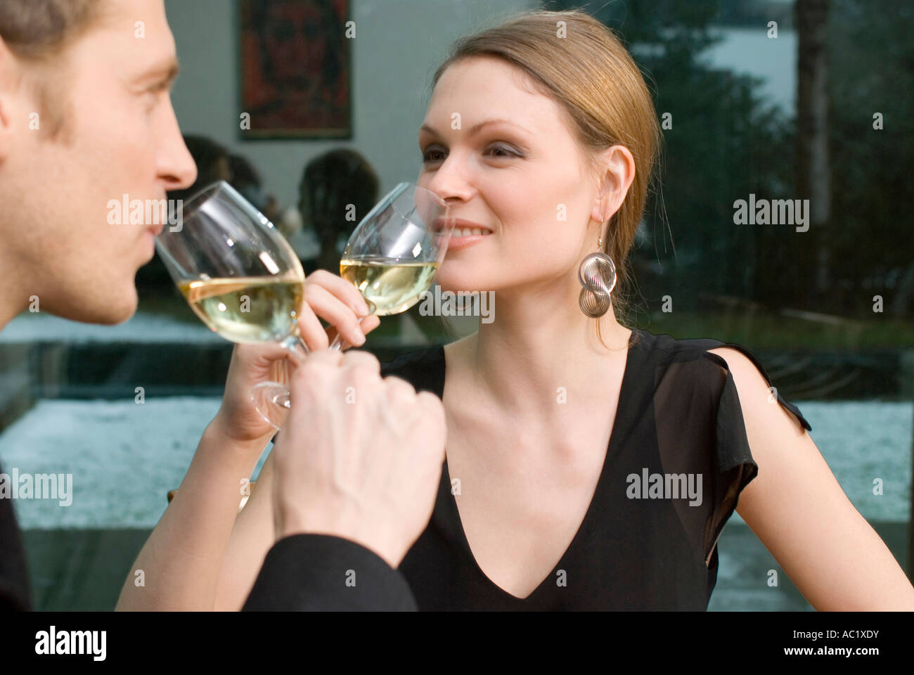 Young couple drinking white wine Stock Photo - Alamy