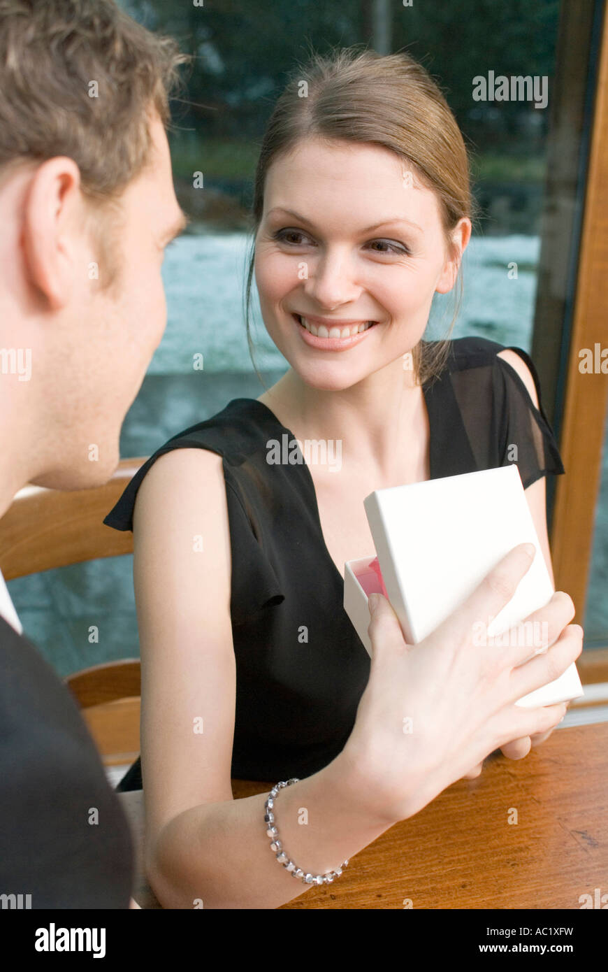 Woman opening a gift parcel Stock Photo - Alamy
