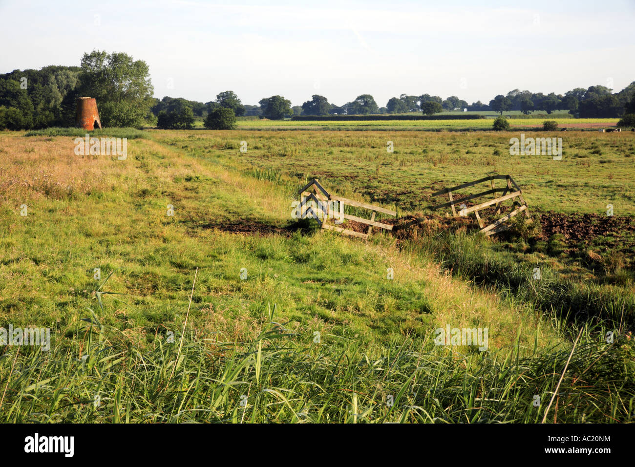 A landscape of grazing marshes with the derelict Womack Water Drainage ...