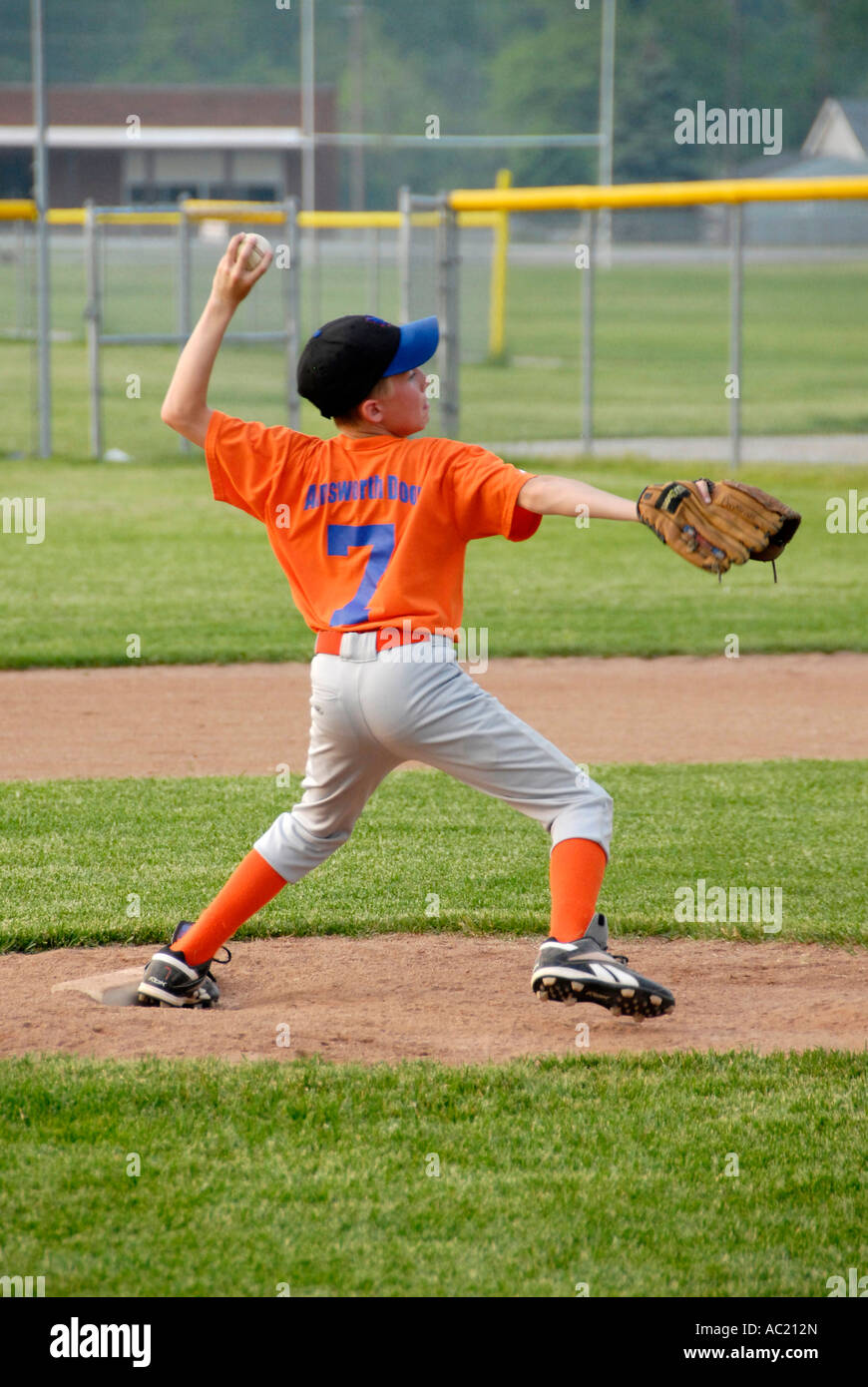 Little League baseball pitcher player throwing a baseball Stock Photo ...